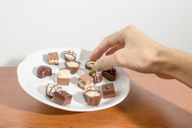 Taking a Chocolate on a Plate on a Table Stock Image - Image of fine ...