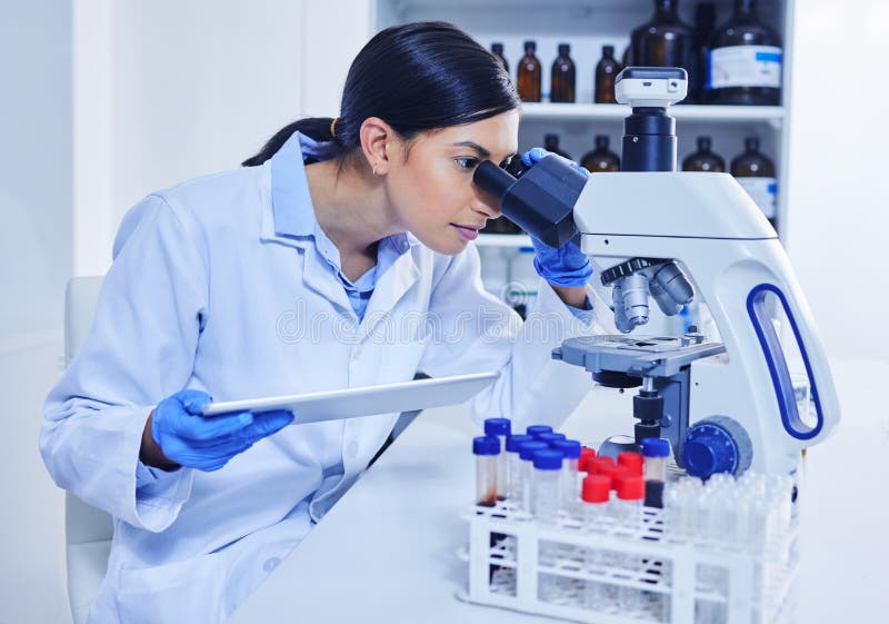 Taking a Closer Look. an Attractive Young Female Scientist Working on a ... Taking a Closer Look. an Attractive Young Female Scientist Working on a ...