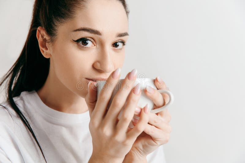 Taking a Coffee Break. Handsome Young Man Holding Coffee Cup, Smiling ... Taking a Coffee Break. Handsome Young Man Holding Coffee Cup, Smiling ...