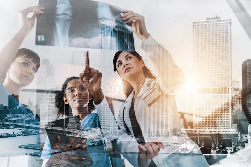 Taking a Deeper Look into the Body. a Group of Doctors Discussing the ...