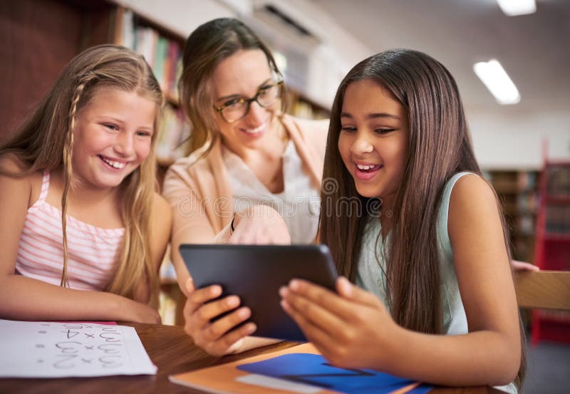 Youre Doing Very Well. a Group of Cheerful Young School Girls Working ...