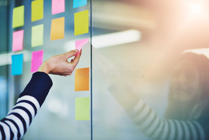 Taking the First Step To Change. a Woman Pasting Notes on Glass during ...