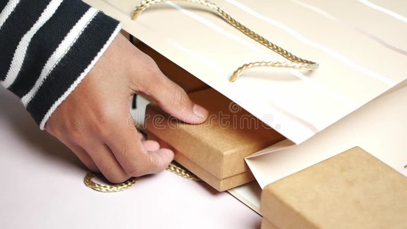 Taking a Gift Out from a Packet on Table Stock Footage - Video of ...