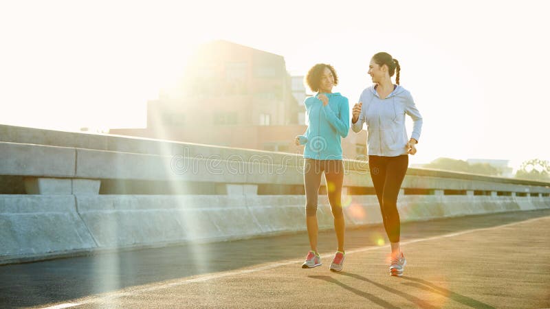 Taking in a Jog Together. Two Friends Jogging Together in the City ...