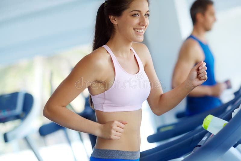 Taking the Next Step To Fitness. a Young Man and Woman Exercising on ... Taking the Next Step To Fitness. a Young Man and Woman Exercising on ...
