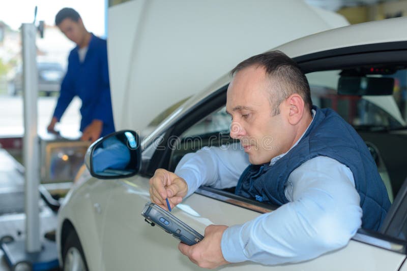 Taking notes car repairs stock photo. Image of performance - 99455624
