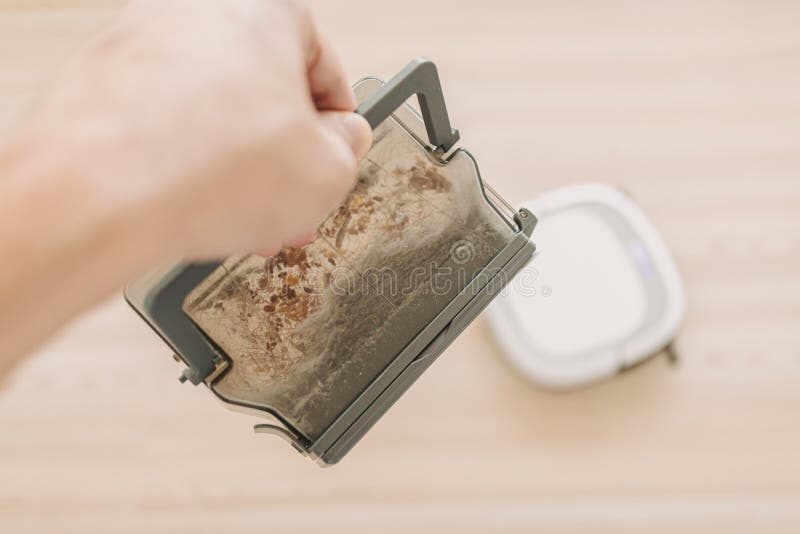 Taking Off Dirty Dust Out of Vacuum Robot Cleaner. Stock Photo - Image ...