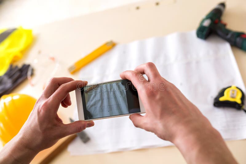 Taking a Pic of Project Plans Stock Photo - Image of looking ...