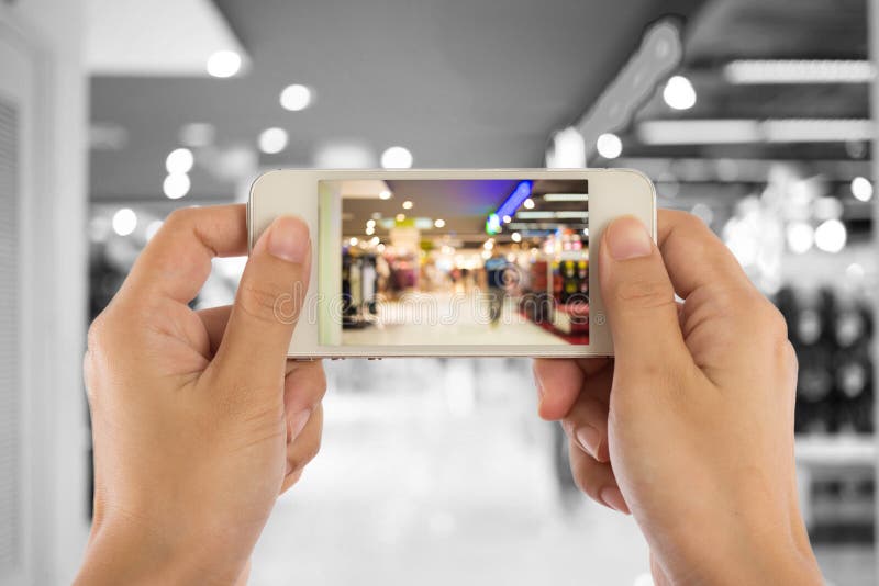 Taking a Picture with a Smart Phone in Shopping Mall. Stock Image ...