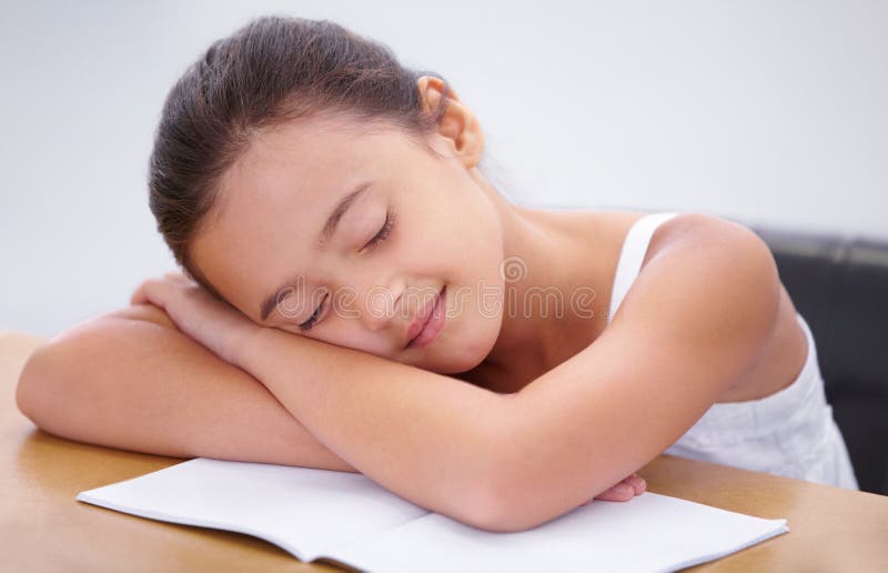 Taking a Rest from Her Studies. a Little Girl Sleeping in Her Desk in ...