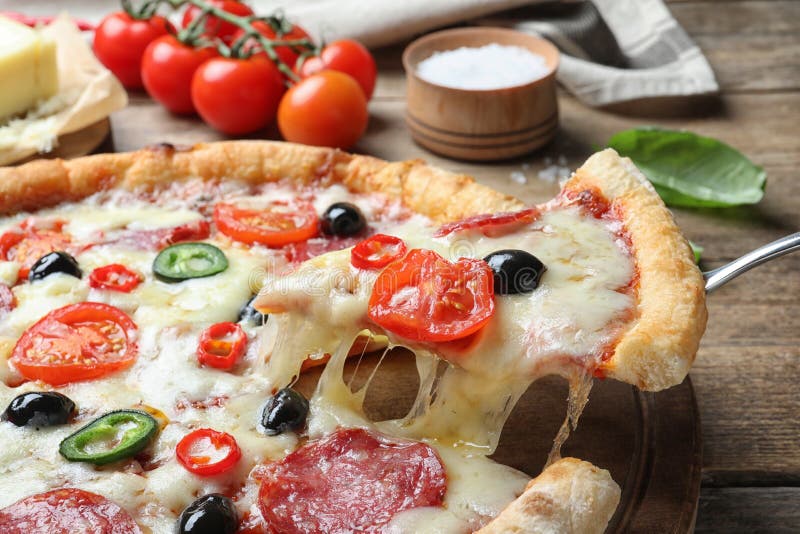 Taking Slice of Delicious Pizza Diablo on Table, Closeup Stock Image ...