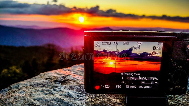 Taking Sunset Photo with a Camera in the Mountains Stock Image - Image ...