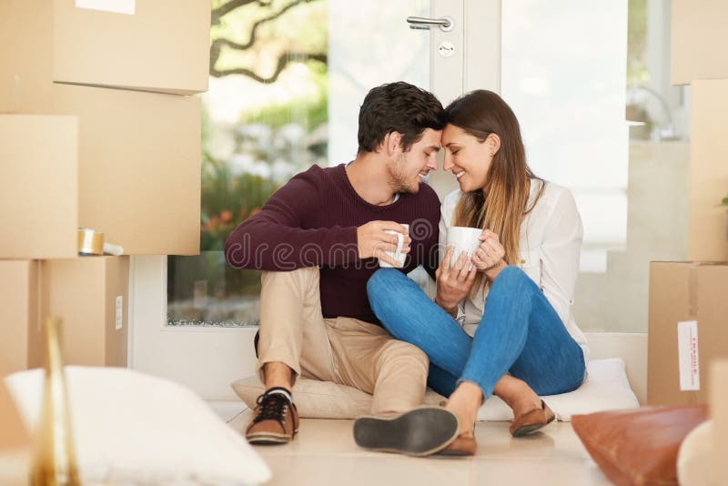 Taking a Timeout on Moving Day. an Affectionate Young Couple Taking a ...