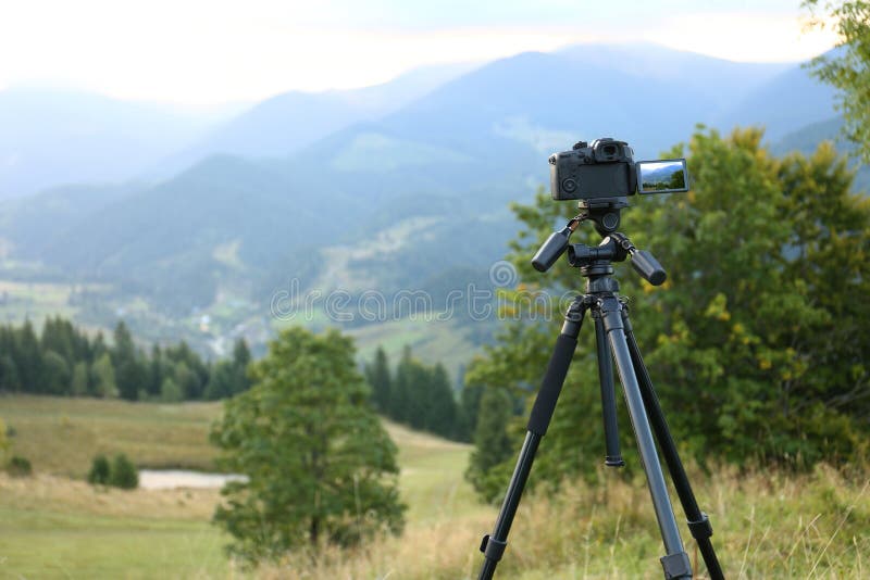Taking Video with Modern Camera on Tripod in Mountains Stock Photo ...