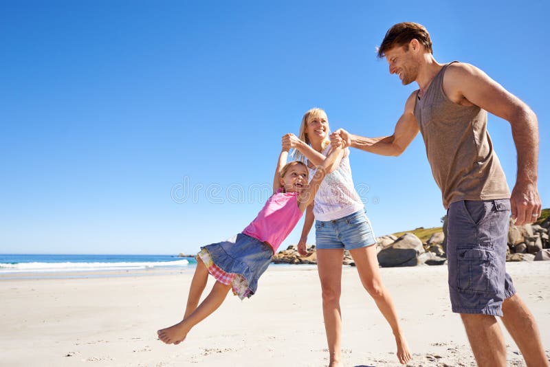 Taking a Walk. a Happy Young Family Taking a Walk on the Beach. Stock ...