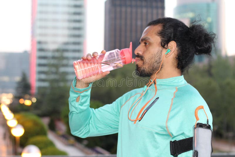 Taking a Water Break after Jogging Stock Photo - Image of adult ...