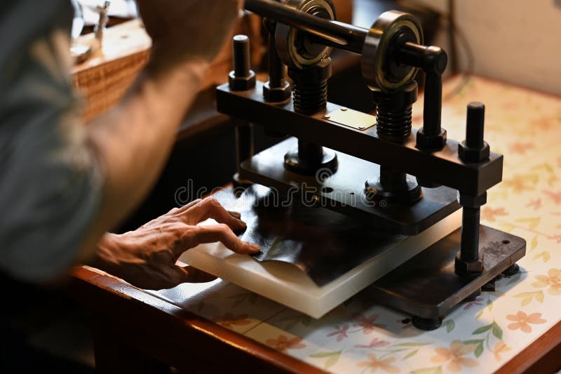 Talented Artisan Using a Manual Press Machine, Working on a Leather ...