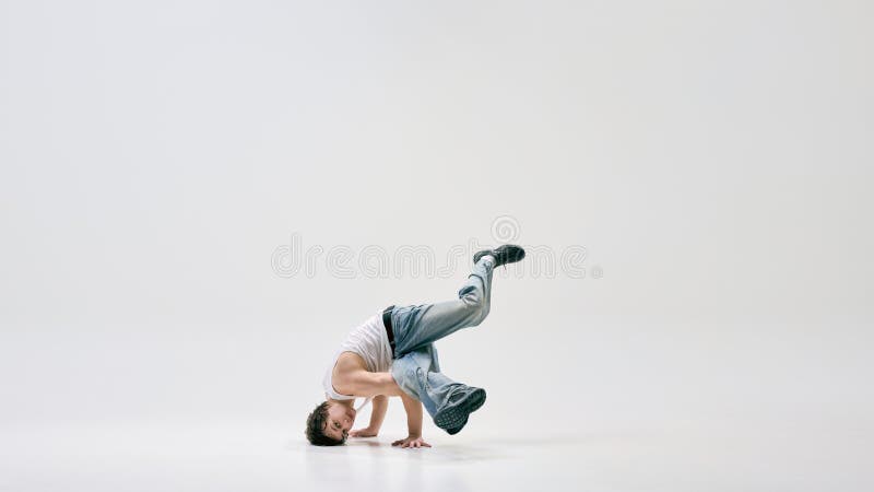 Young Breakdancer Balancing on One Hand Against White Background. Ffull ...