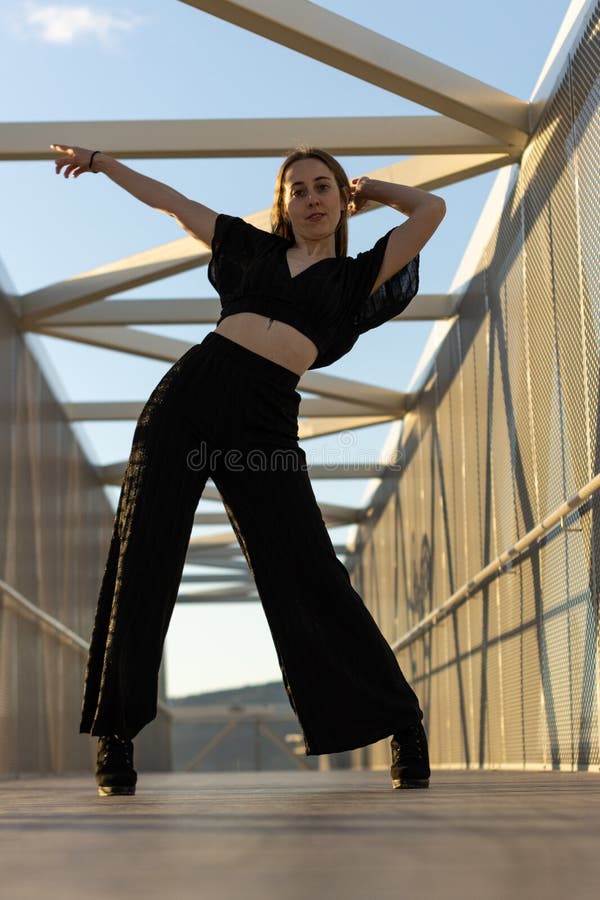 Young Dancer Performing Modern Dance on a Bridge at Sunset Stock Photo ...