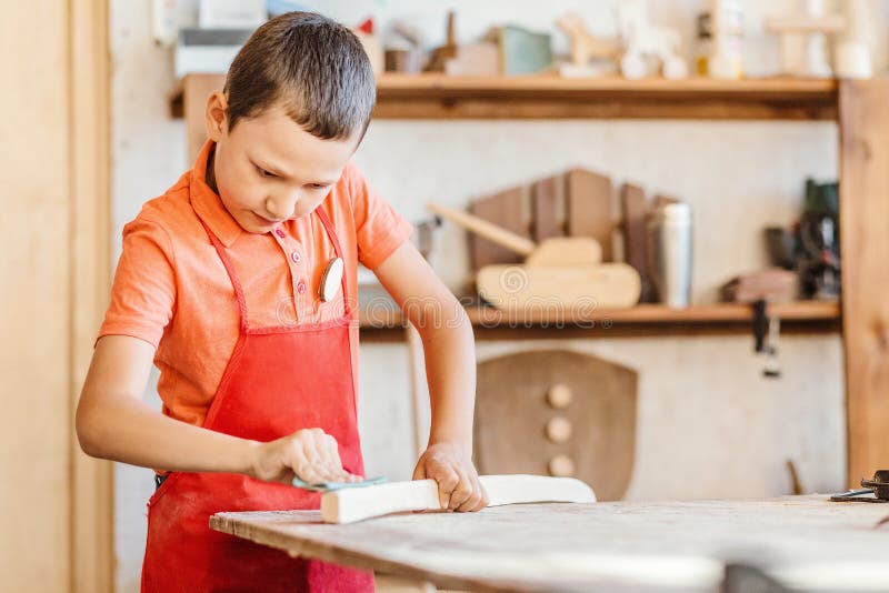 Talented Genius Boy Works with Wood in a Carpentry Workshop. the ...