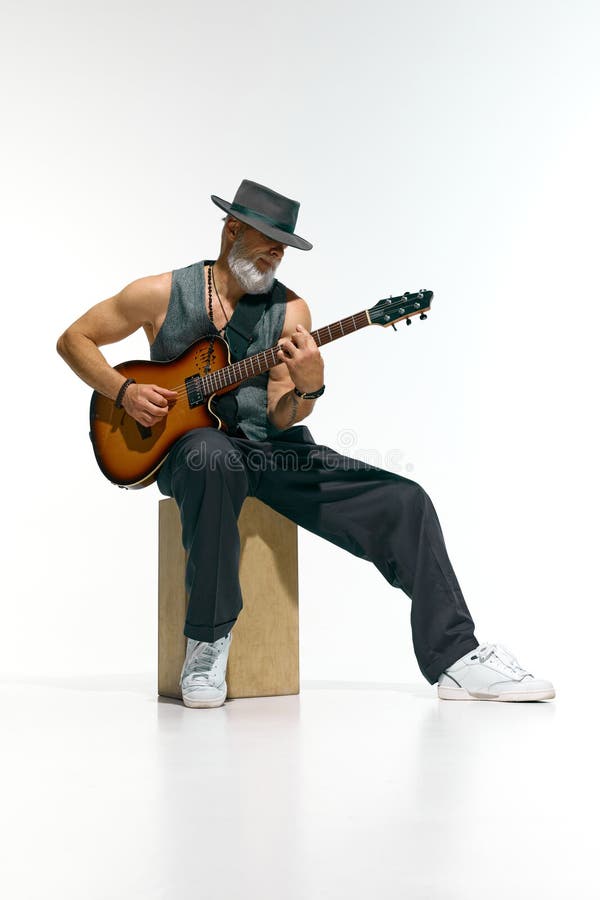 Talented Man with White Beard and Hat Captured in Midst of Energetic ...