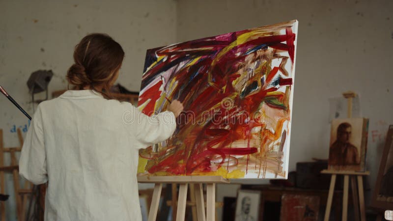 Talented Woman Creating at Workplace. Painter Using Bright Colors ...