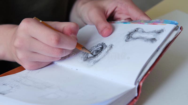 Talented Young Artist Draws in a Notebook. Pencil Drawing of an Eye ...