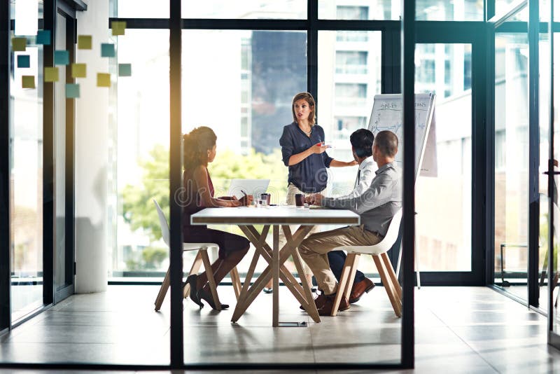 Talking Business Tactics. a Group of Colleagues Having a Meeting in a ...
