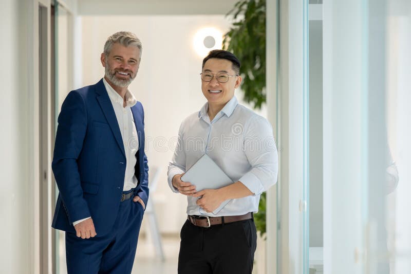 Men Standing in Corridor in Office and Talking about Their Work. Stock ...