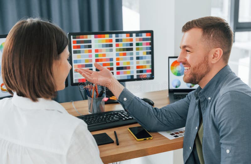 Talking and Creating Content. Two Designers Working Together in the ...