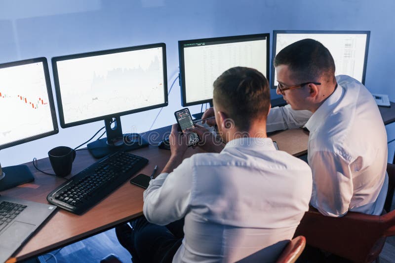 Talking with Each Other. Two Stock Traders Working in the Office with ...