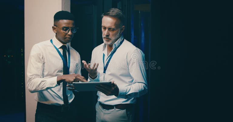 Talking, Hardware and Men in Server Room on Tablet for Network Solution ...