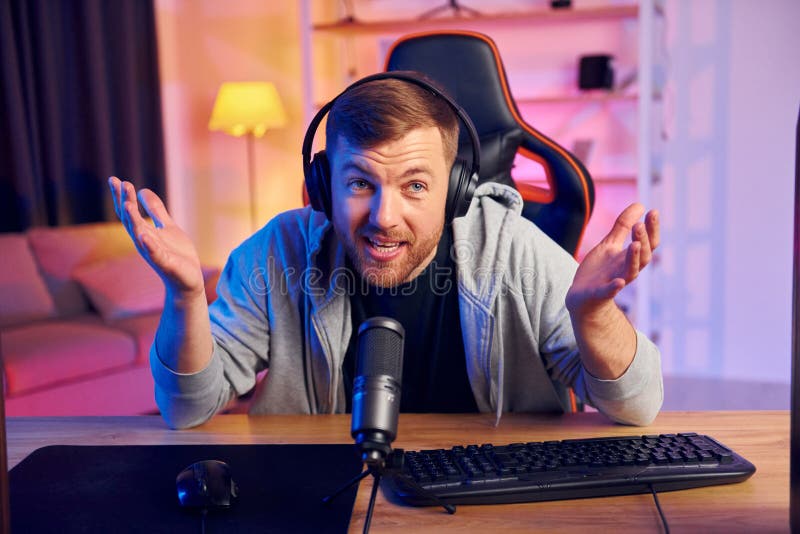 Talking into the Microphone To Online Audience. Man in Headphones and ...