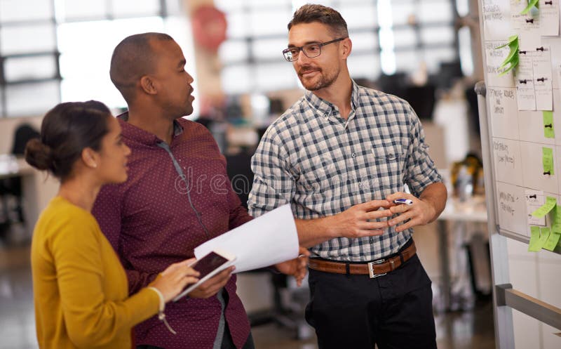 Talking Out the Details of Their Project. a Group of Coworkers ...