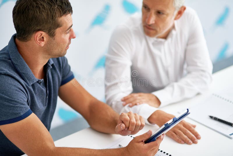 Talking it Over. High Angle Shot of Two Men Working in the Office ...