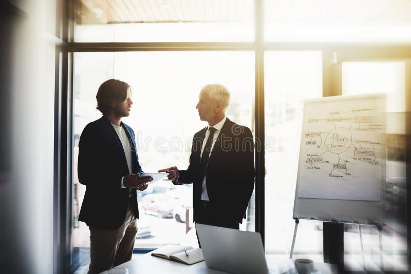 Talking Things Over in the Office. Two Business Colleagues Talking ...