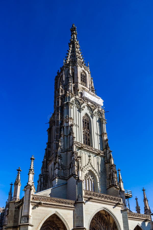 Tall Belltower of Bern Cathedral on Blue Sky Background Stock Image ...
