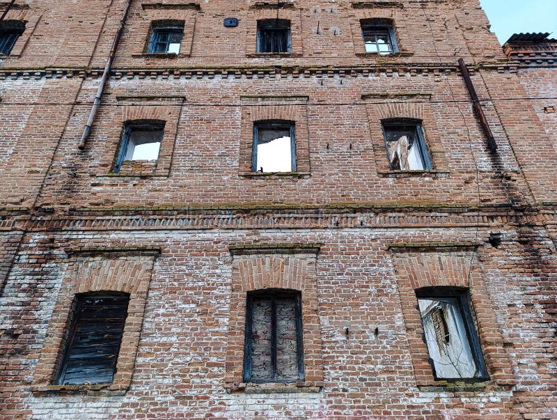 A Tall Brick Building with Broken Windows and Broken Windows Stock ...