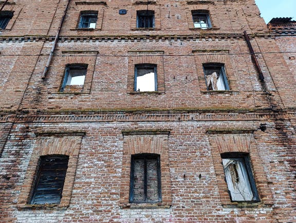 A Tall Brick Building with Broken Windows and Broken Windows Stock ...