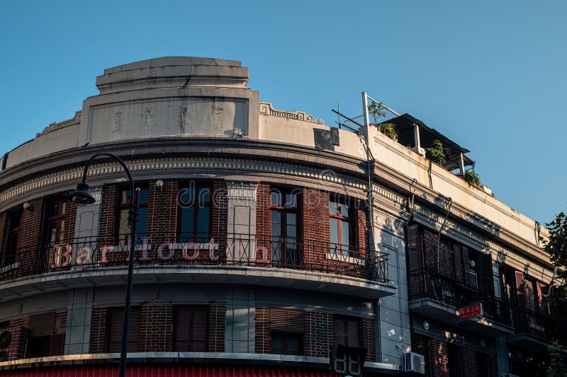A Tall Brick Building Has an Elaborate Roof on the Corner Editorial ...