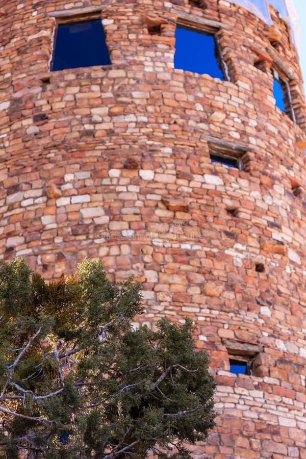 A Tall Brick Building with a Tree in Front of it Stock Photo - Image of ...