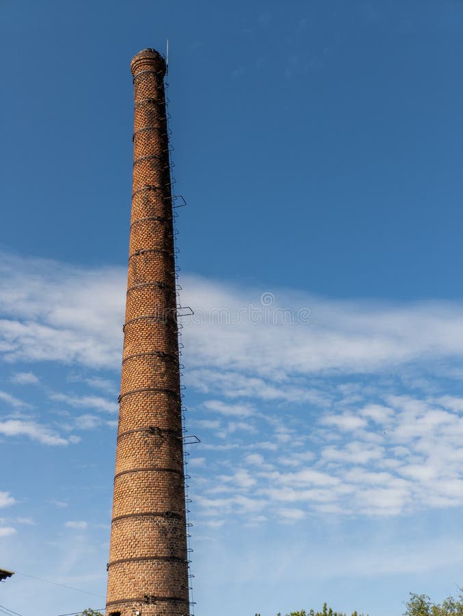 A Tall Brick Chimney with a Blue Sky in the Background Stock Photo ...