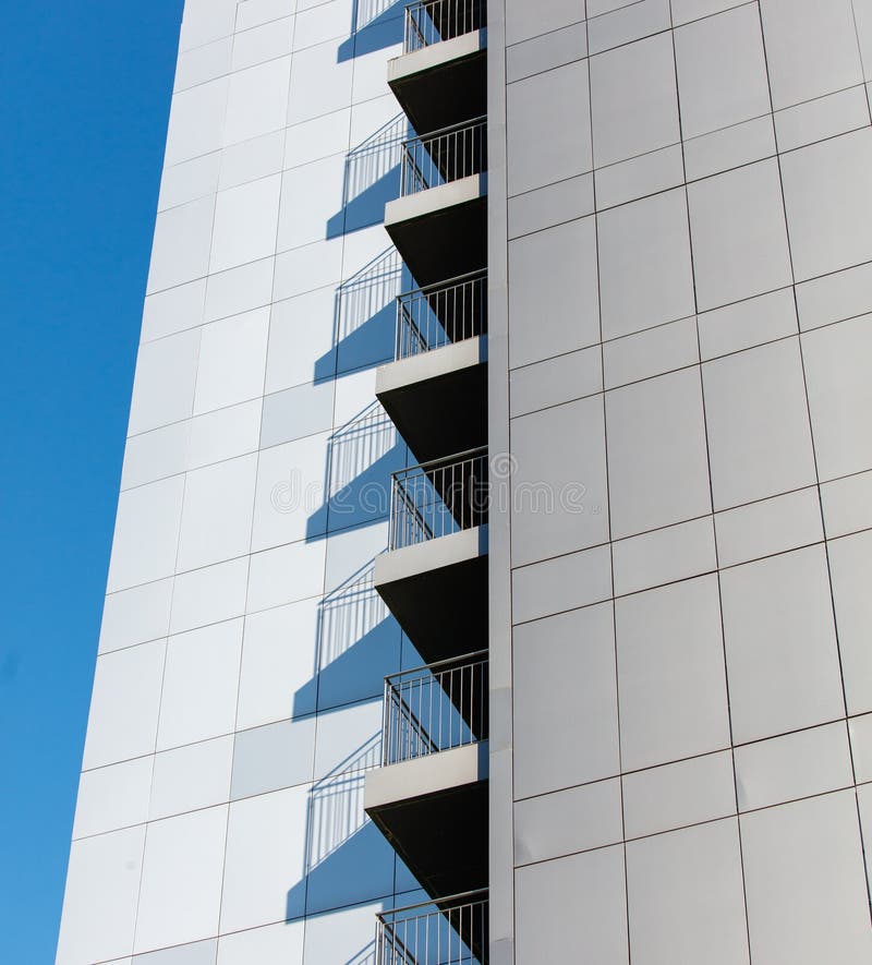 A Tall Building with a Balcony on the Side Stock Image - Image of ...