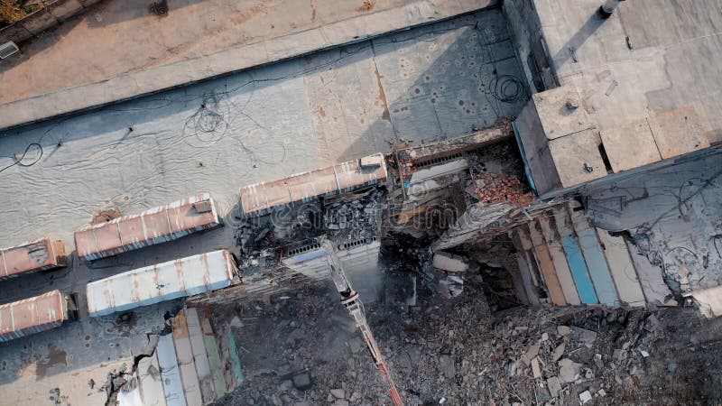 Tall Building Destroyed. Demolition Machine Tearing Down Roof of a ...