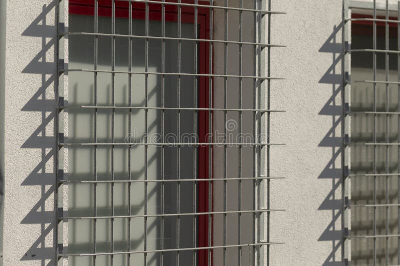 A Tall Building Featuring Numerous Windows Combined with Striking Red ...