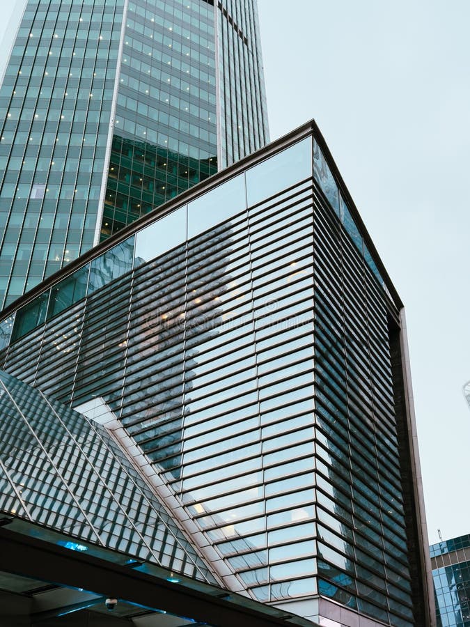 A Tall Building with a Glass Facade and a Triangular Shape Stock Photo ...