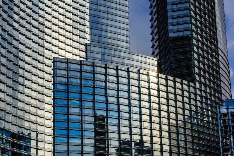 A Tall Building with Many Windows and a Reflection of the Sky Editorial ...