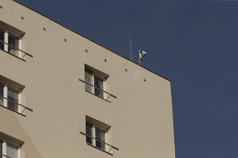 A Tall Building with a Rooftop Camera Against a Blue Sky Stock Image ...