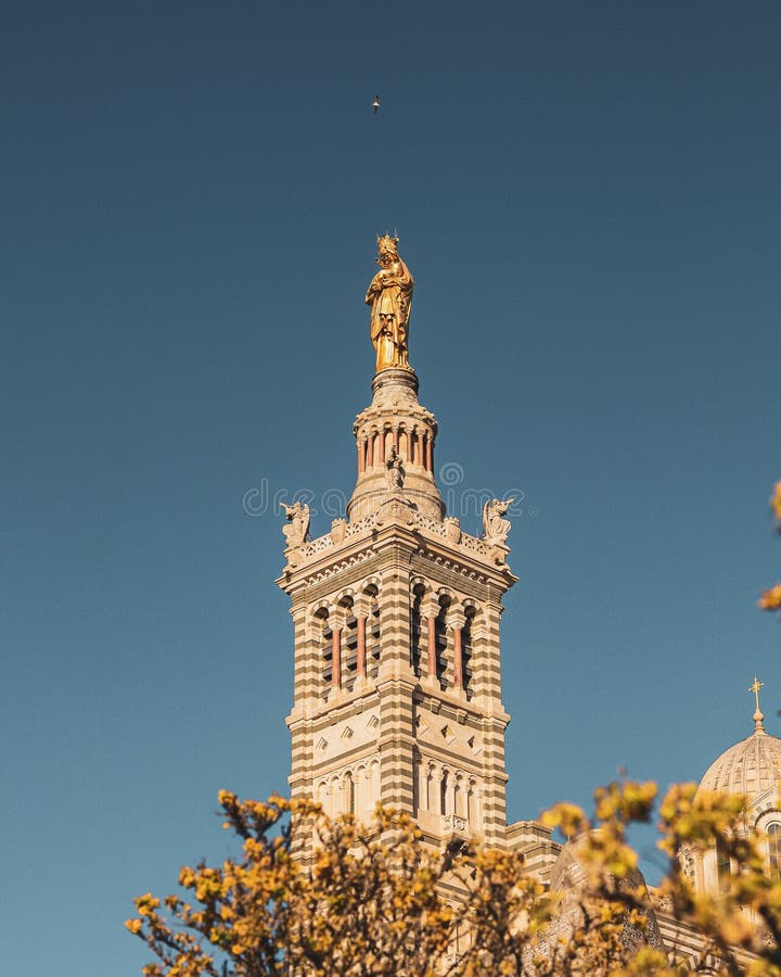 Tall Building with a Statue on Top Stock Image - Image of church ...