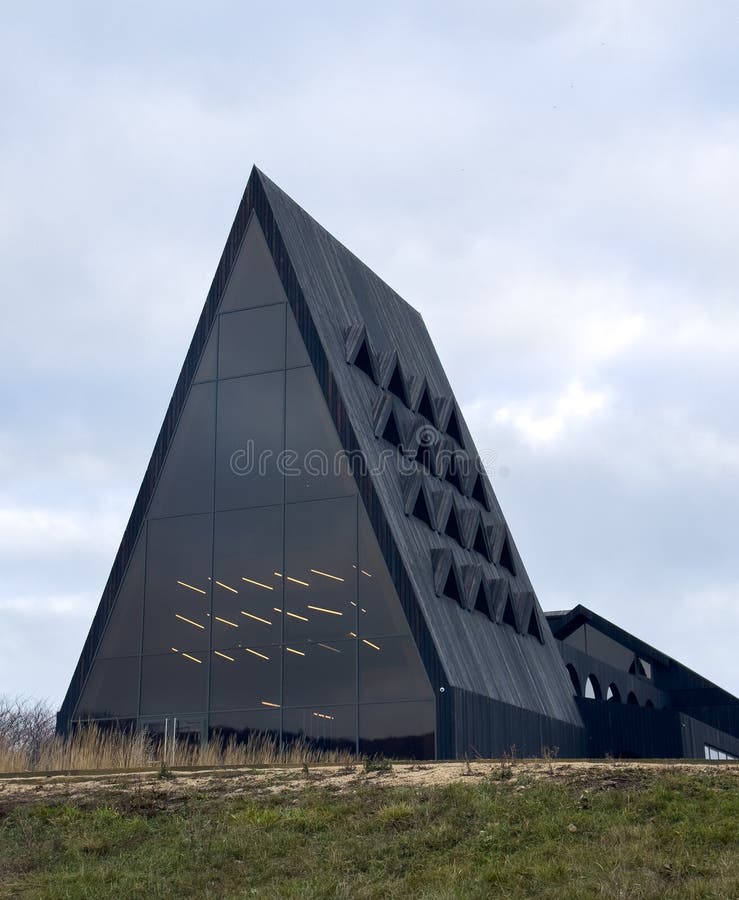 A Tall Building with a Triangular Roof and a Lot of Windows Stock Photo ...